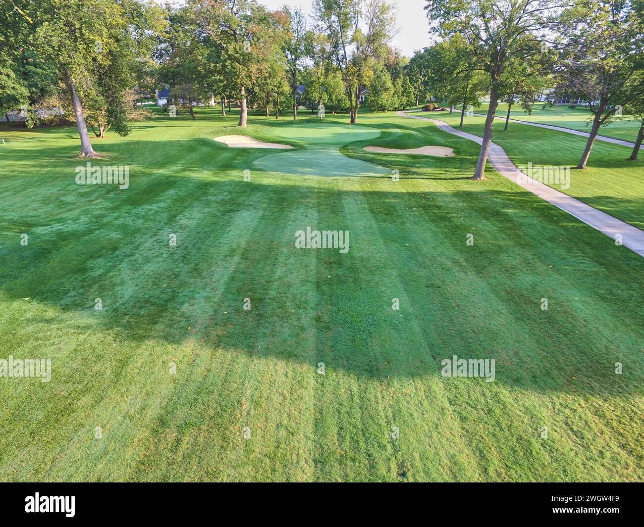Aerial View of Serene Golf Course with Long Shadows and Lush Greens ...