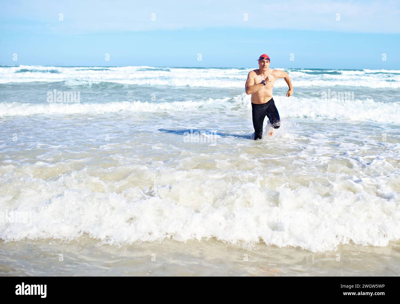 Man running into waves alone hi-res stock photography and images - Alamy