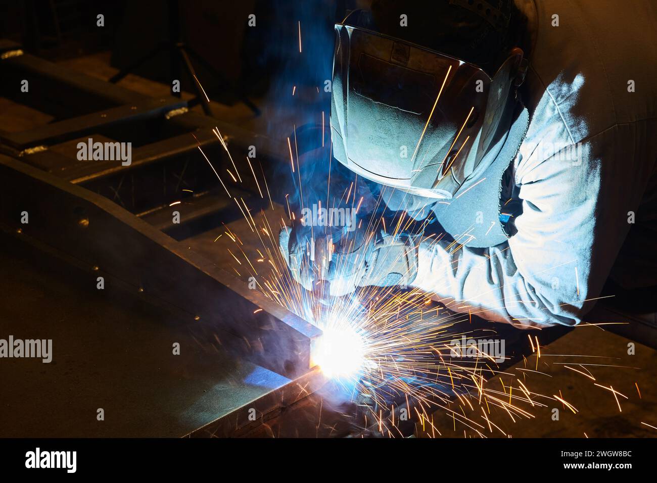 Industrial Welder at Work with Sparks Flying in Workshop Stock Photo ...