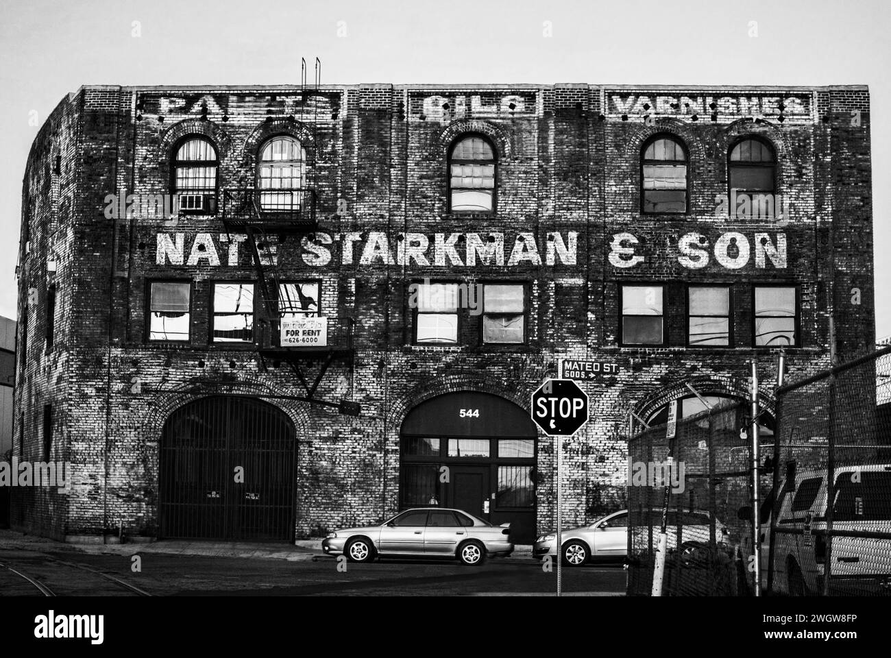 Two-story brick building with a prominent stop sign Stock Photo - Alamy