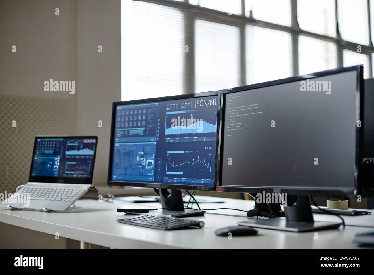 Background image of computer equipment with tech data on screens in ...