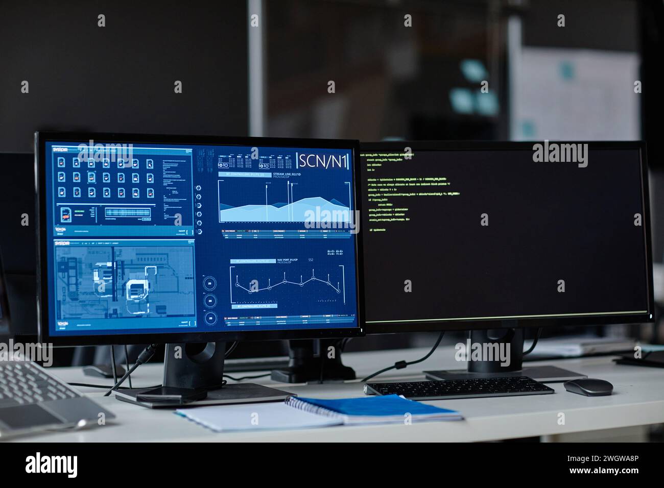 Front view background image of two computers with data charts on screen ...