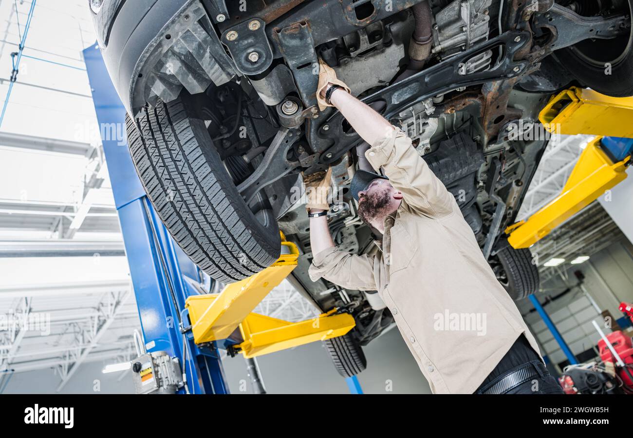 Professional Caucasian Car Mechanic in His 30s Performing Lifted ...