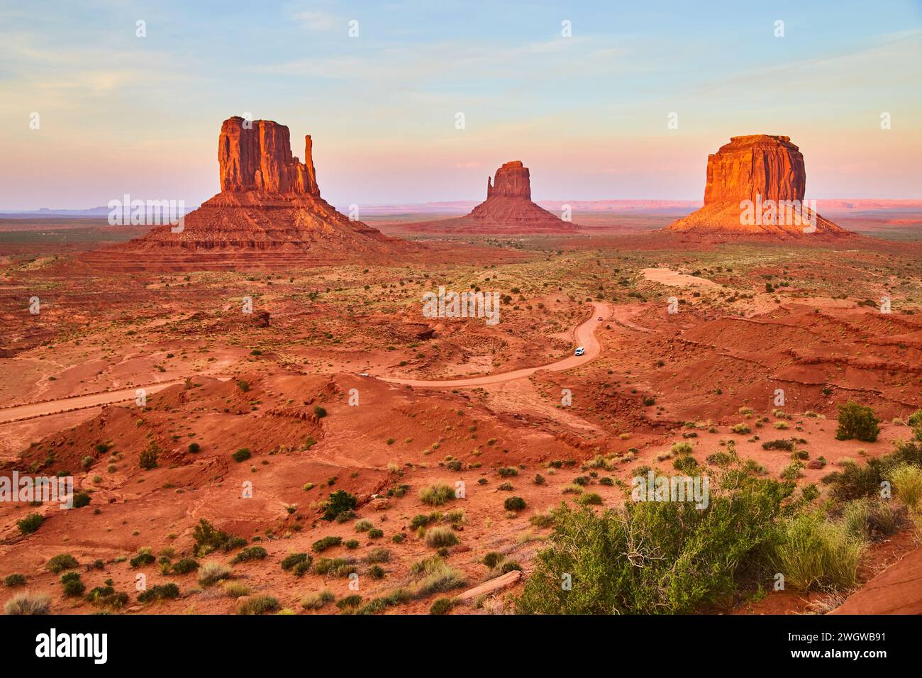 Monument Valley Buttes at Sunrise with Winding Road Stock Photo - Alamy