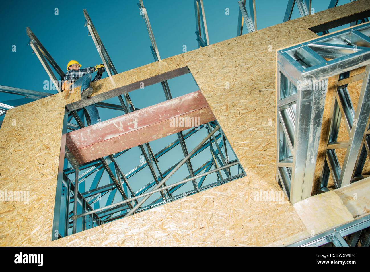 Construction Site Professional Contractor on Top of a Building Skeleton ...
