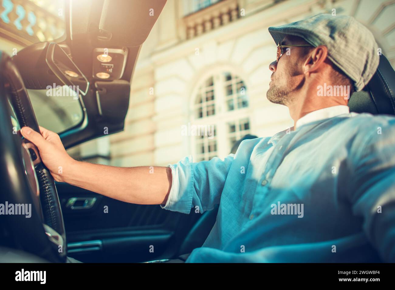Successful Caucasian Man Driving Convertible in Front of His Mansion ...