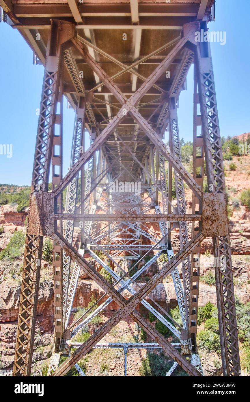 Rusted Steel Truss Bridge Underbelly with Red Rock Background Stock ...