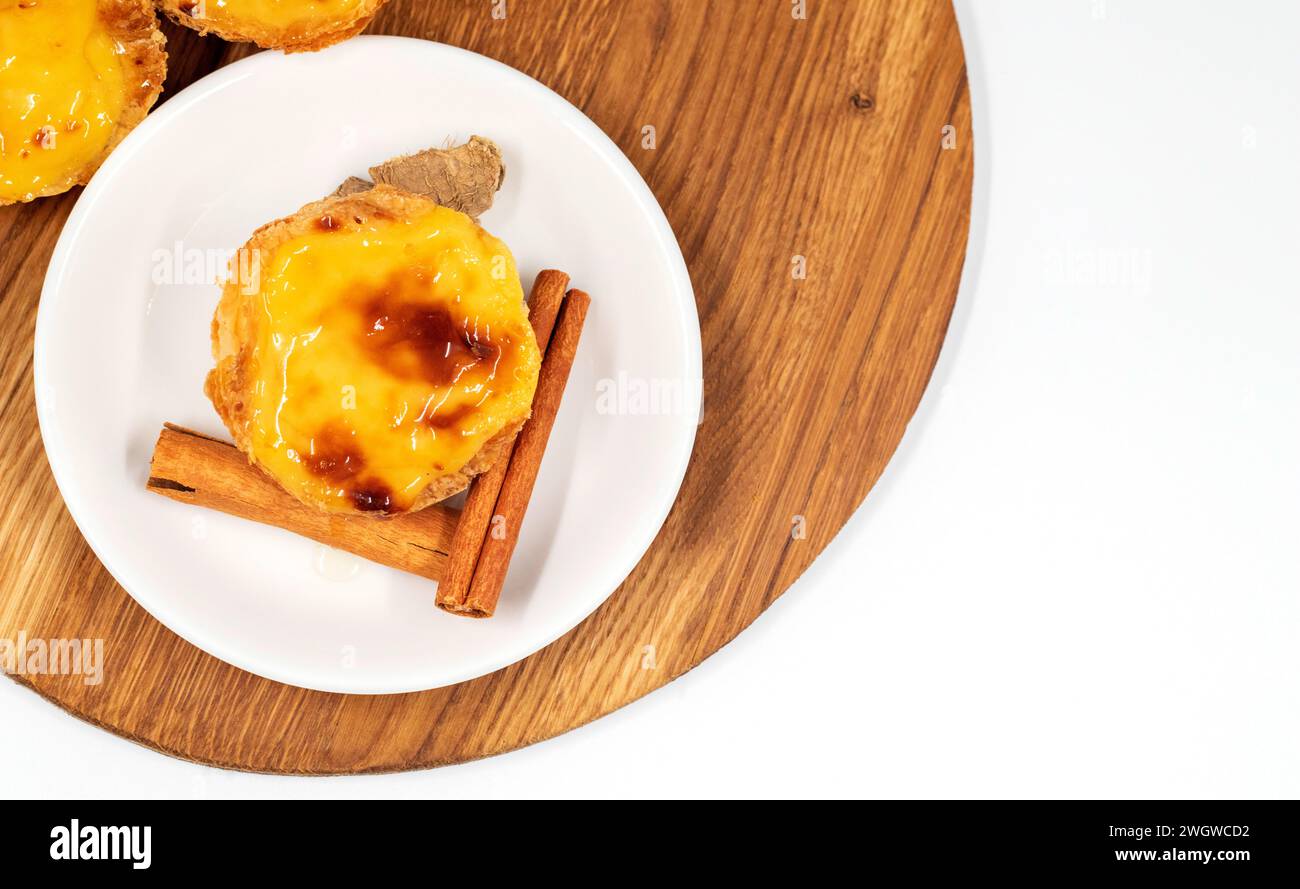 Pastel de nata tarts or Portuguese egg tart and cinnamon sticks ...