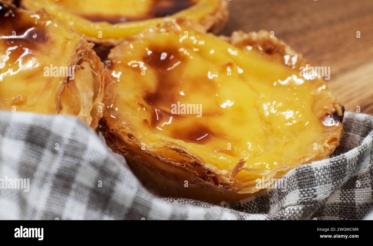 Pastel de nata tarts or Portuguese egg tart on a wooden brown ...