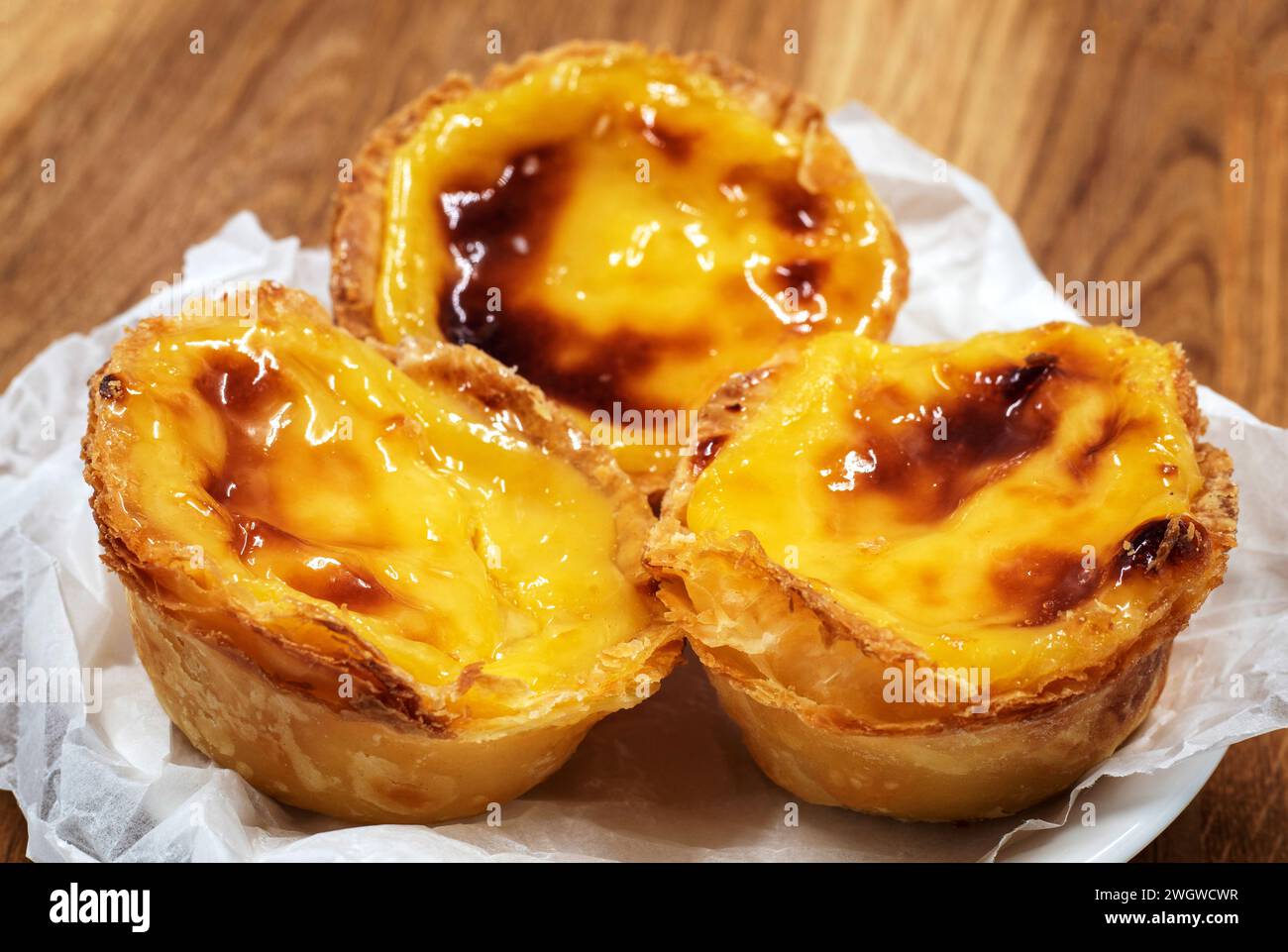 Pastel de nata tarts or Portuguese egg tart on a wooden brown ...