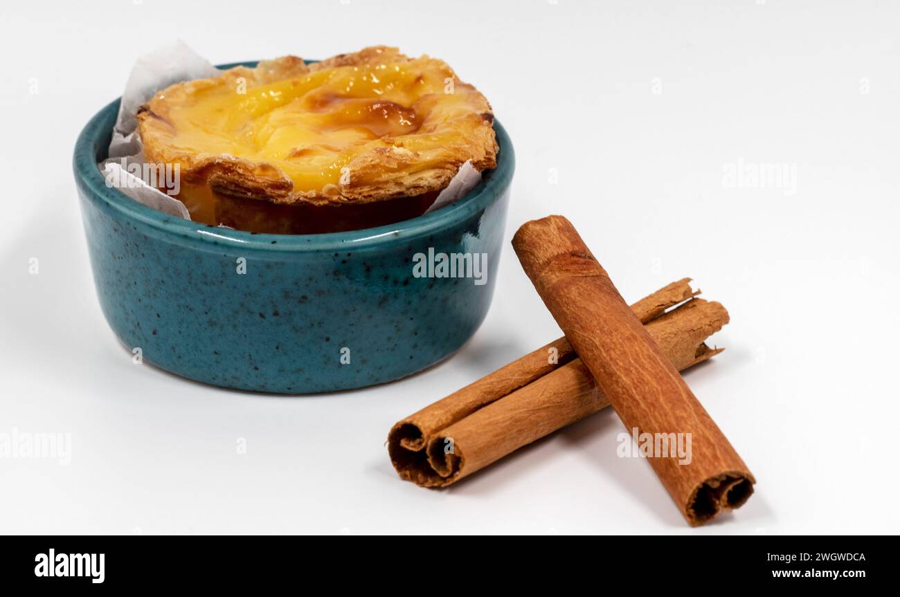 Pastel de nata tarts or Portuguese egg tart and cinnamon sticks ...