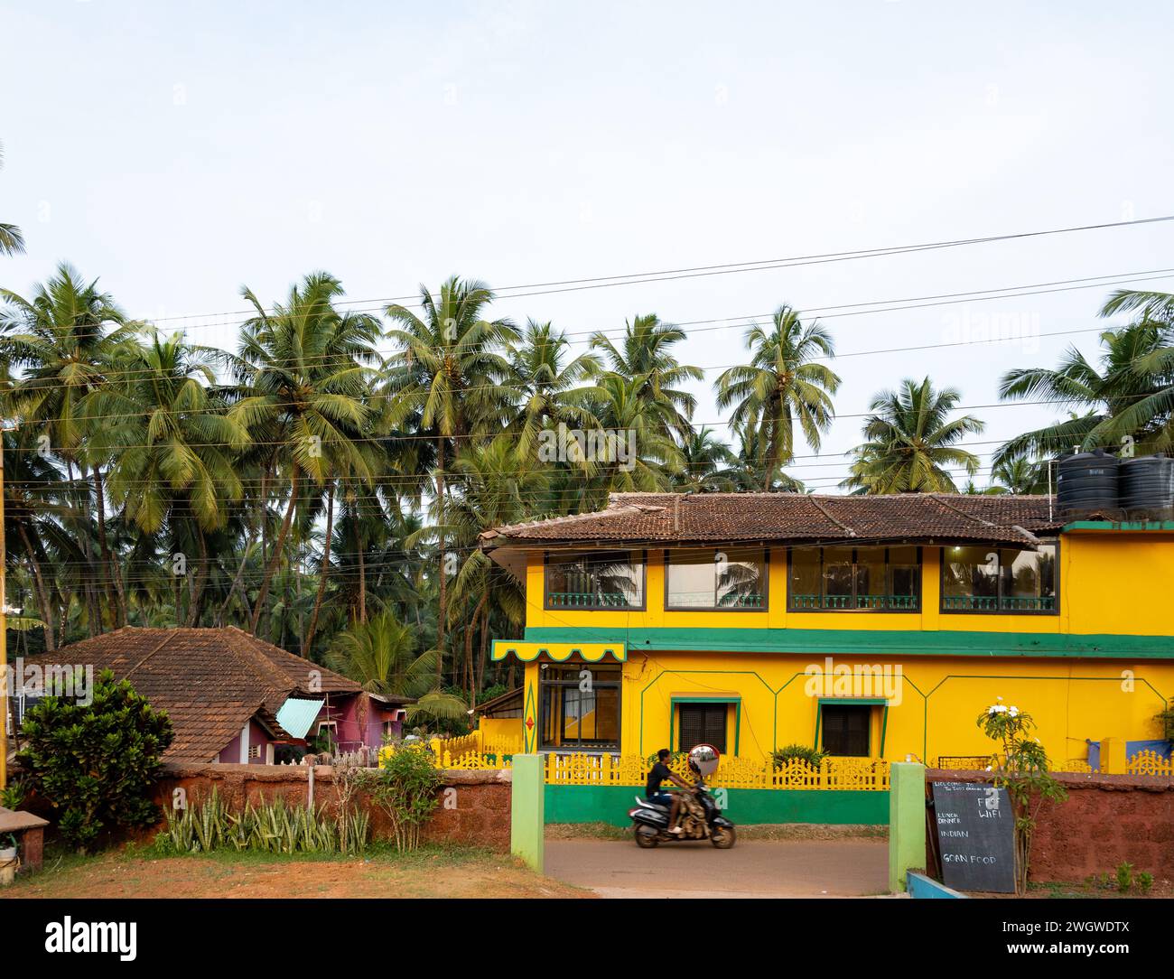 Agonda, Goa, India, Yellow colonial house in the street of south Goa ...