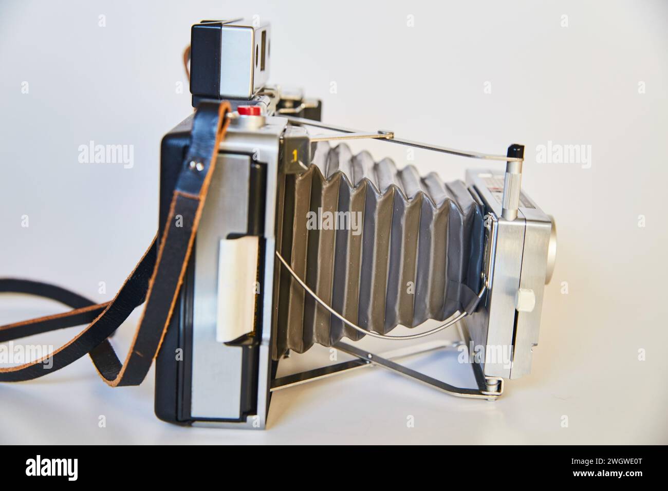 Vintage Bellows Camera with Leather Strap on Cream Background Stock ...