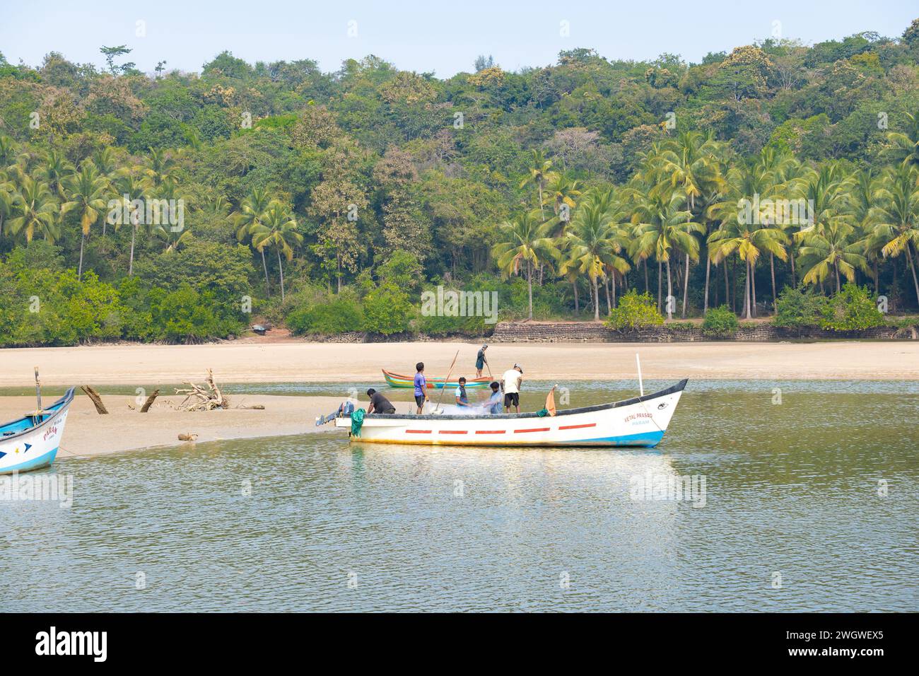 Agonda, Goa, India, Fisherman in the boat at a lagoon of Agonda beach ...