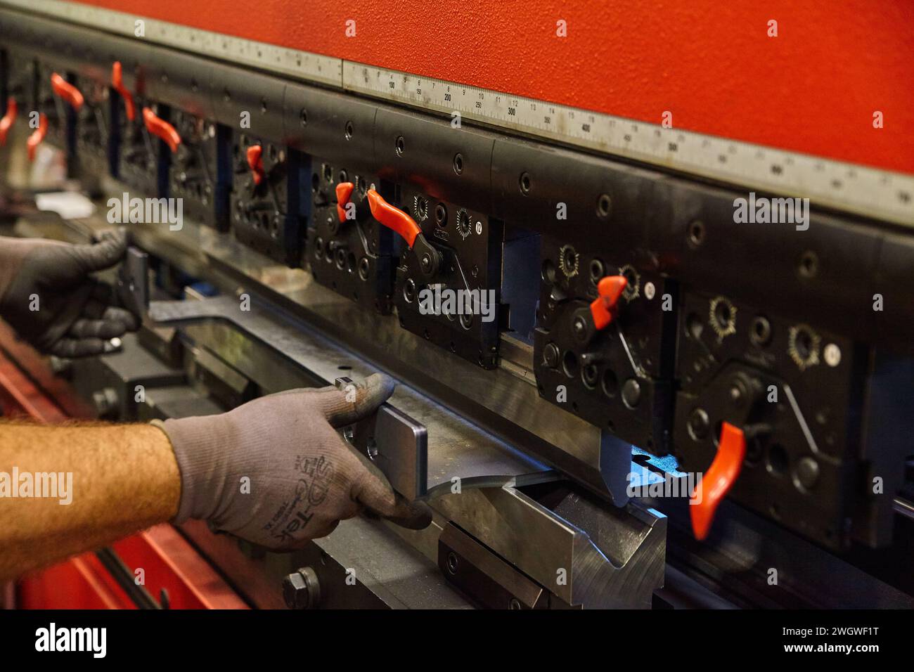 Skilled Worker Using Industrial Metal Press with Precision Gloves Stock ...