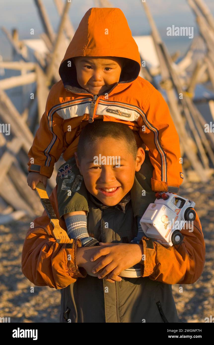 Eskimo Inupiat kids playing at camp on a sandspit along Demarcation bay ...