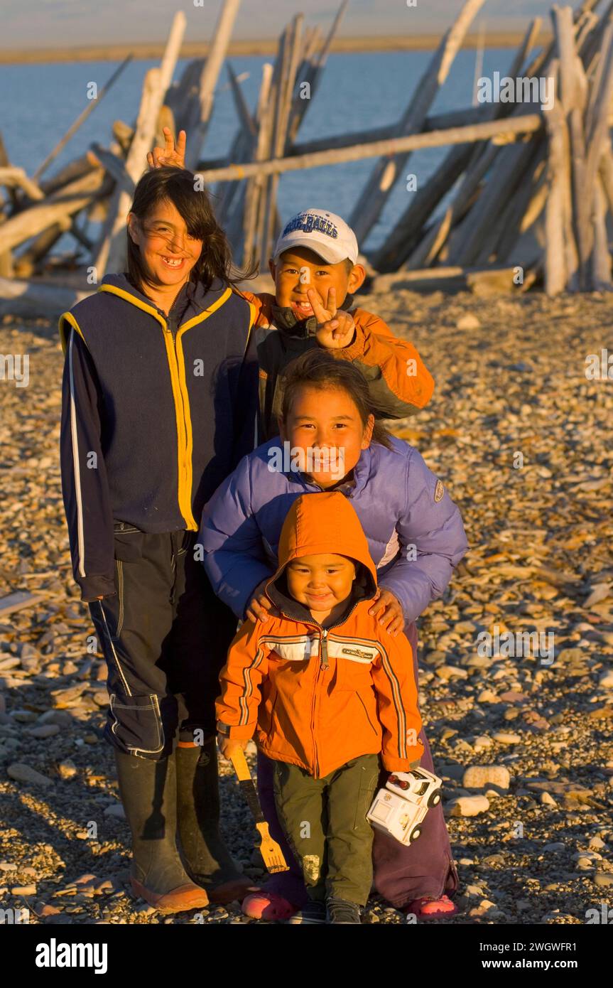 Eskimo Inupiat kids playing at camp on a sandspit along Demarcation bay ...