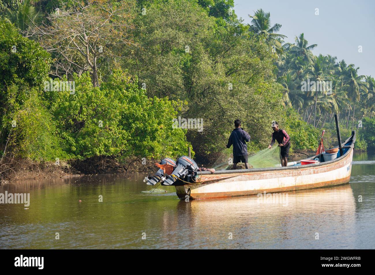 Agonda, Goa, India, Fisherman in the boat at a lagoon of Agonda beach ...