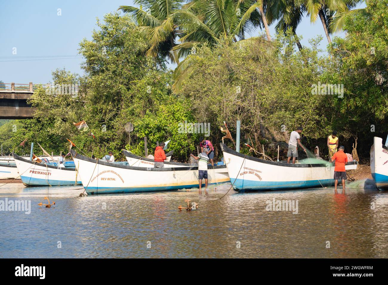 Agonda, Goa, India, Fishermen preparing a fishing net on the boat ...