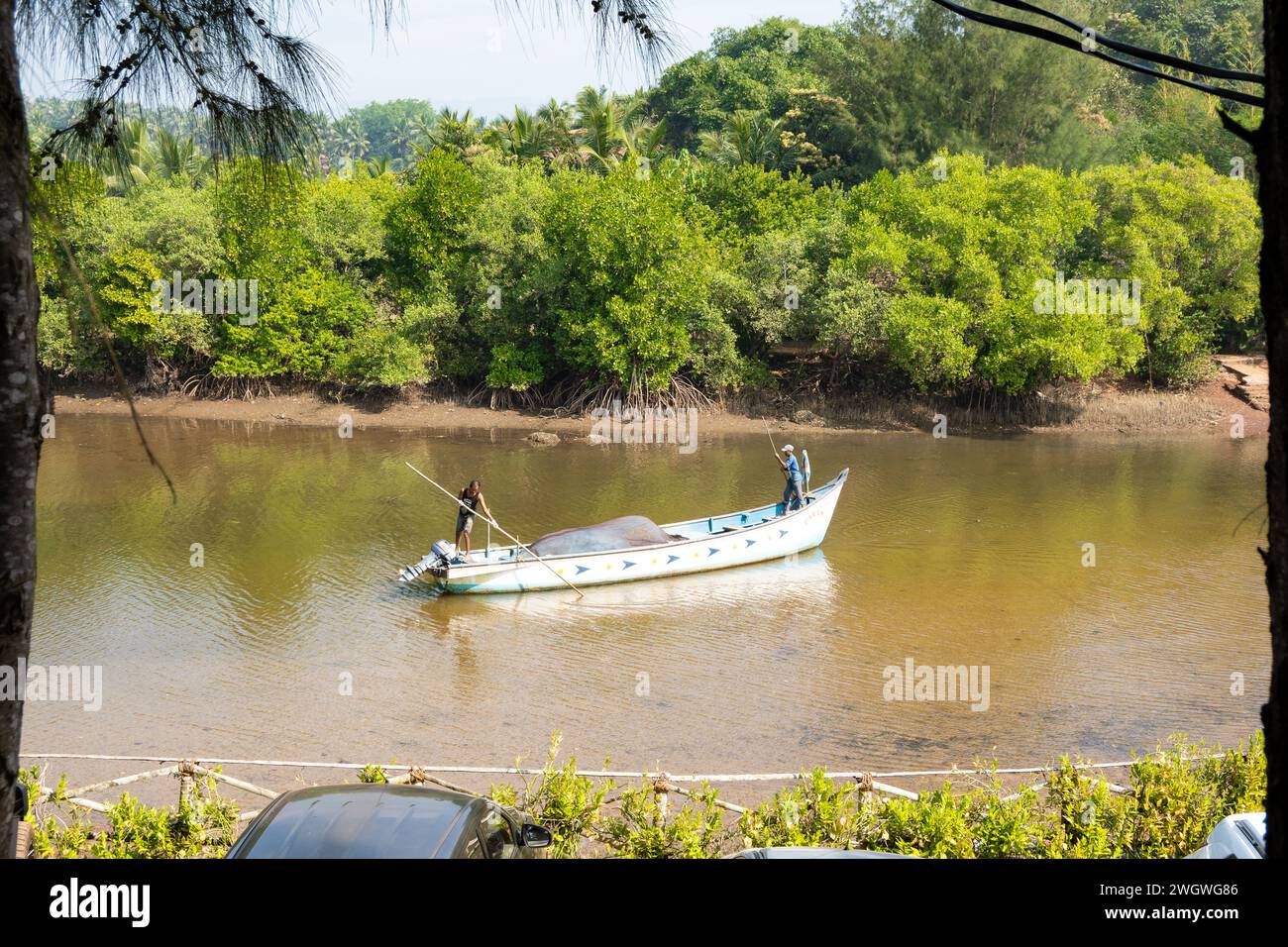 Agonda, Goa, India, Fisherman in the boat at a lagoon of Agonda beach ...