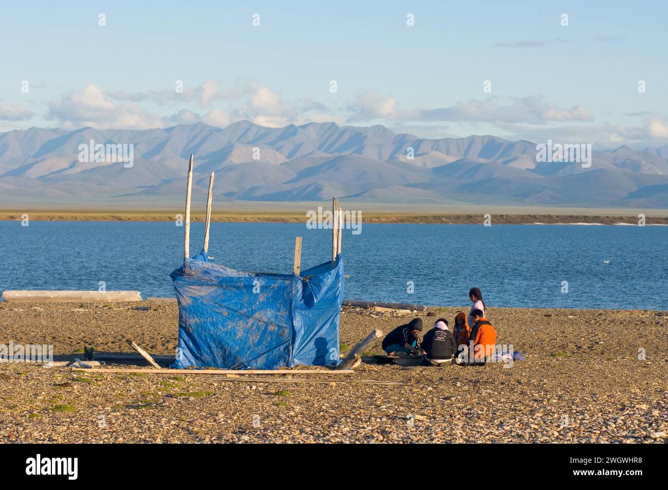 Eskimo Inupiat kids and elder playing at camp on a sandspit along ...