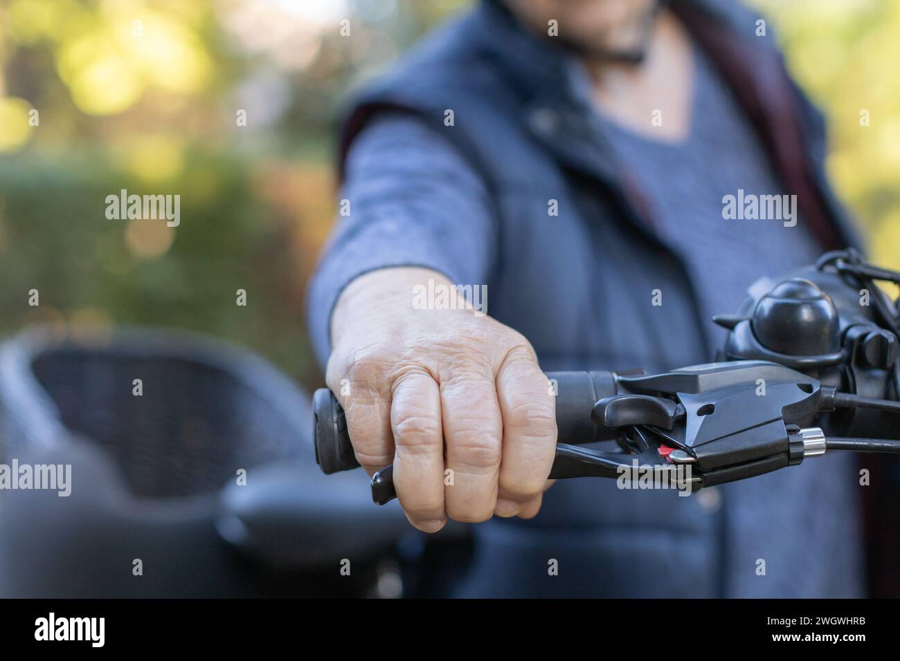 elderly woman's hand on bicycle handle Stock Photo - Alamy