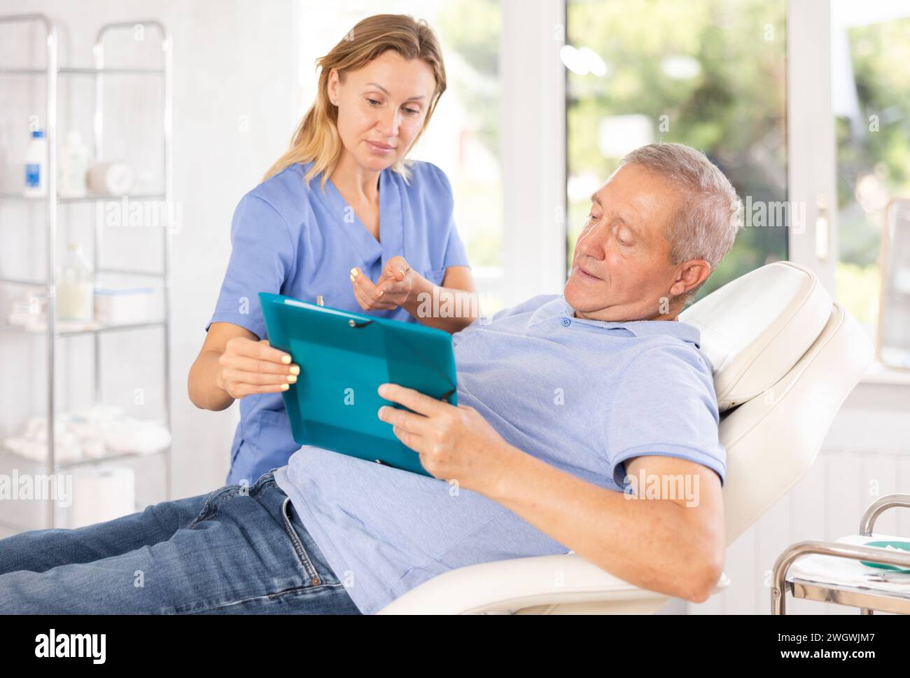 Adult woman doctor giving contract to patient for signing Stock Photo ...