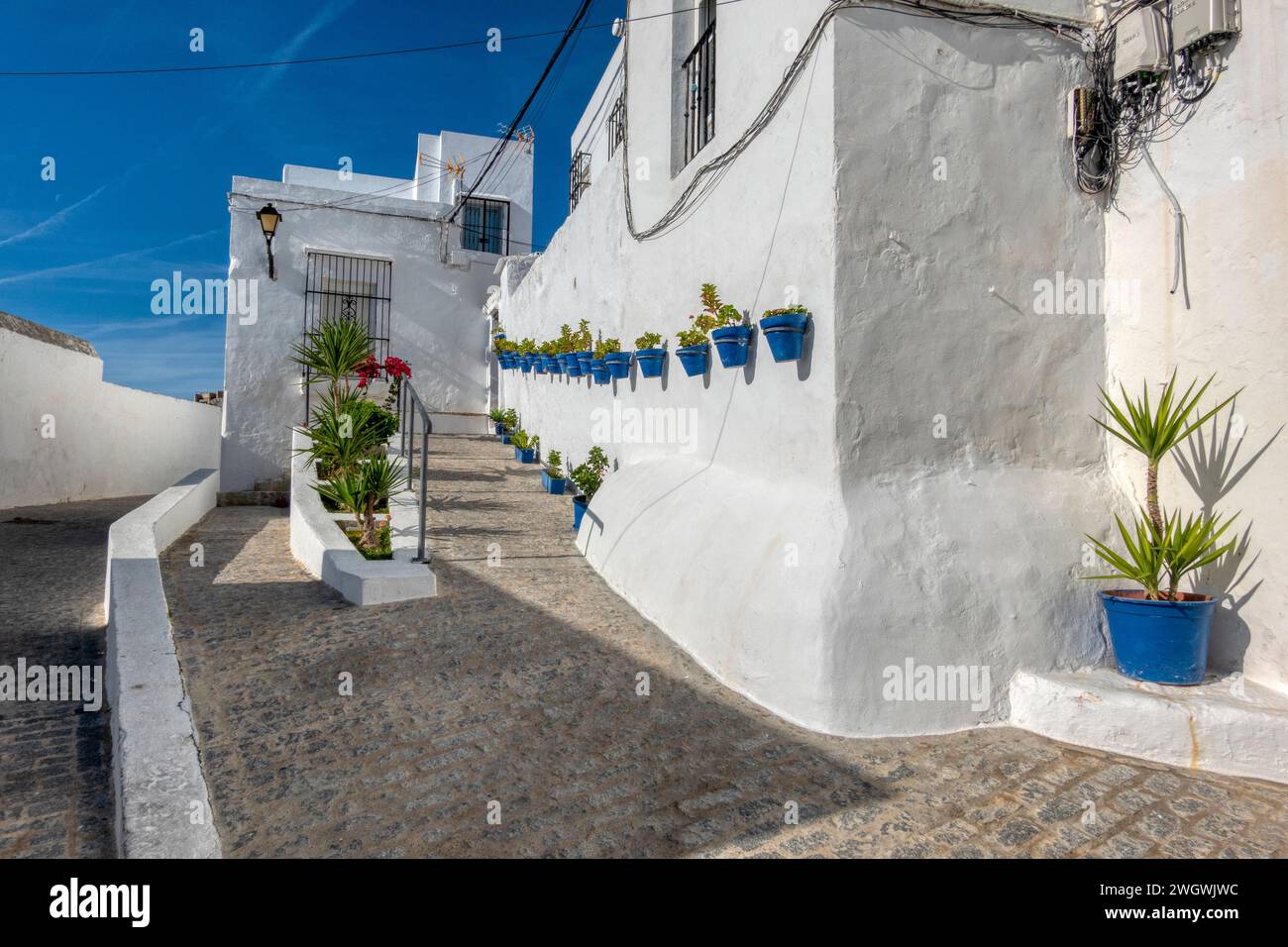 Picturesque street in Vejer de la Frontera, a beautiful white village ...