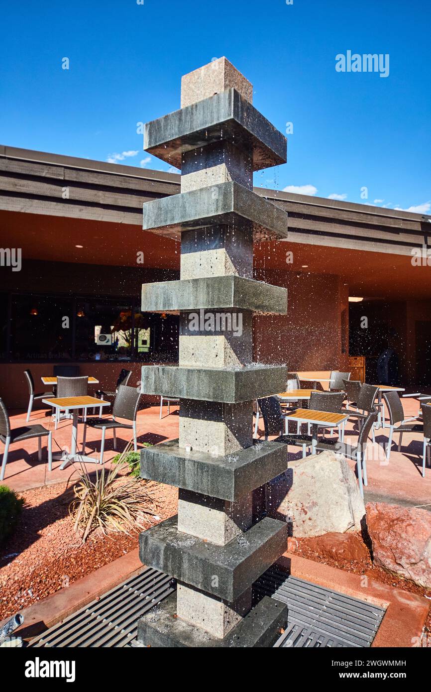 Modern Stone Fountain with Outdoor Cafe Seating in Sunlight Stock Photo ...