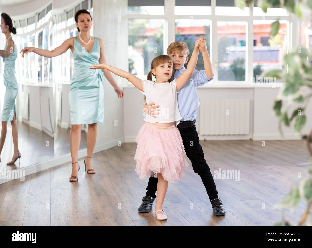 Boy and girl train to dance contemporary vigorous rumba during classes ...