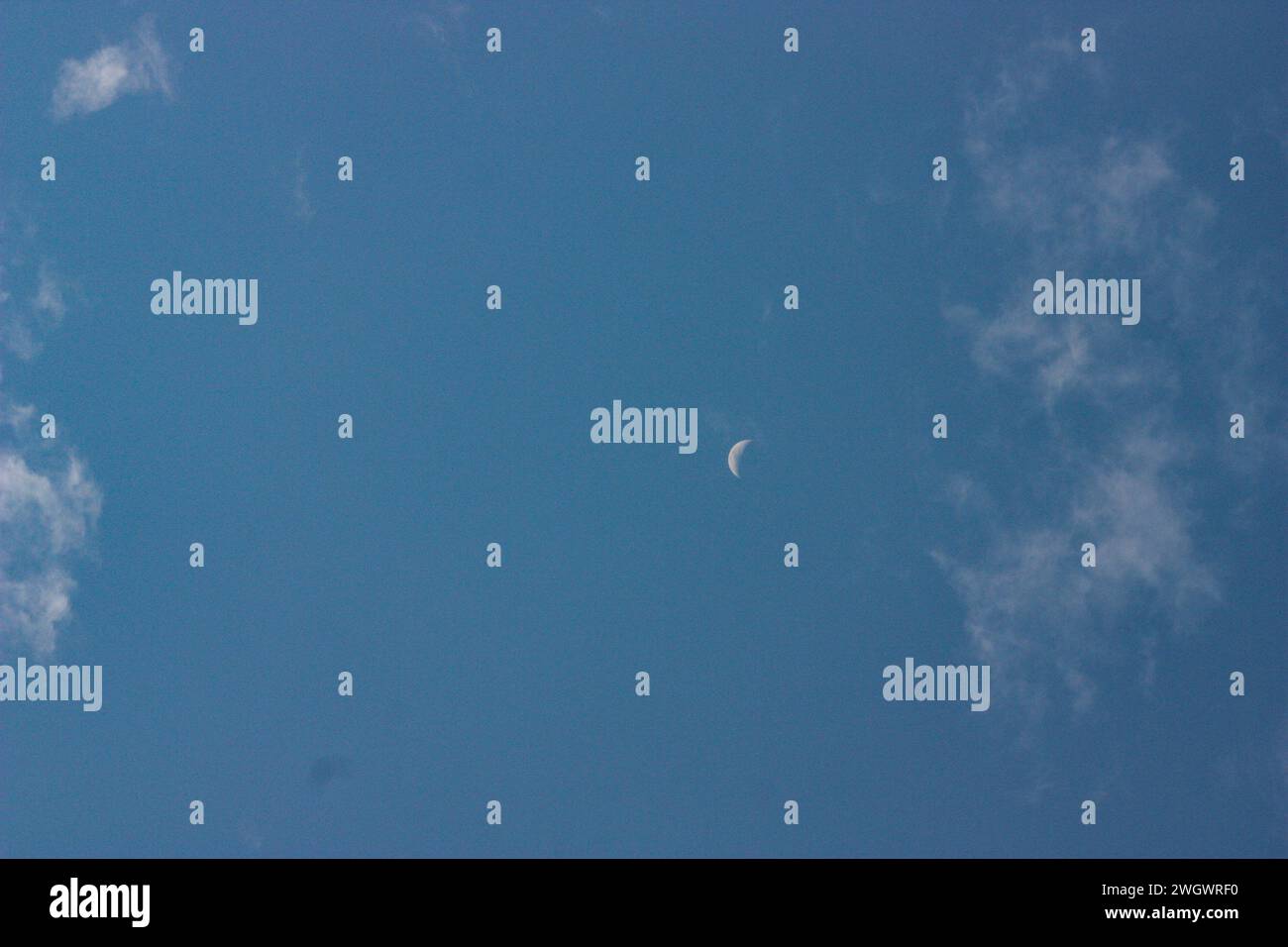 Crescent Moon In The Midle of the Day Stock Photo - Alamy