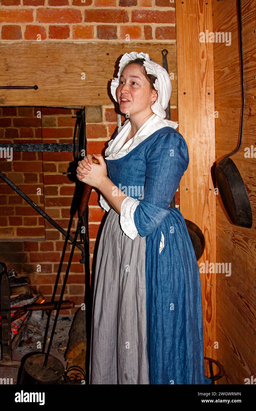 young woman, colonial garb, white cap, blue dress, apron, period ...