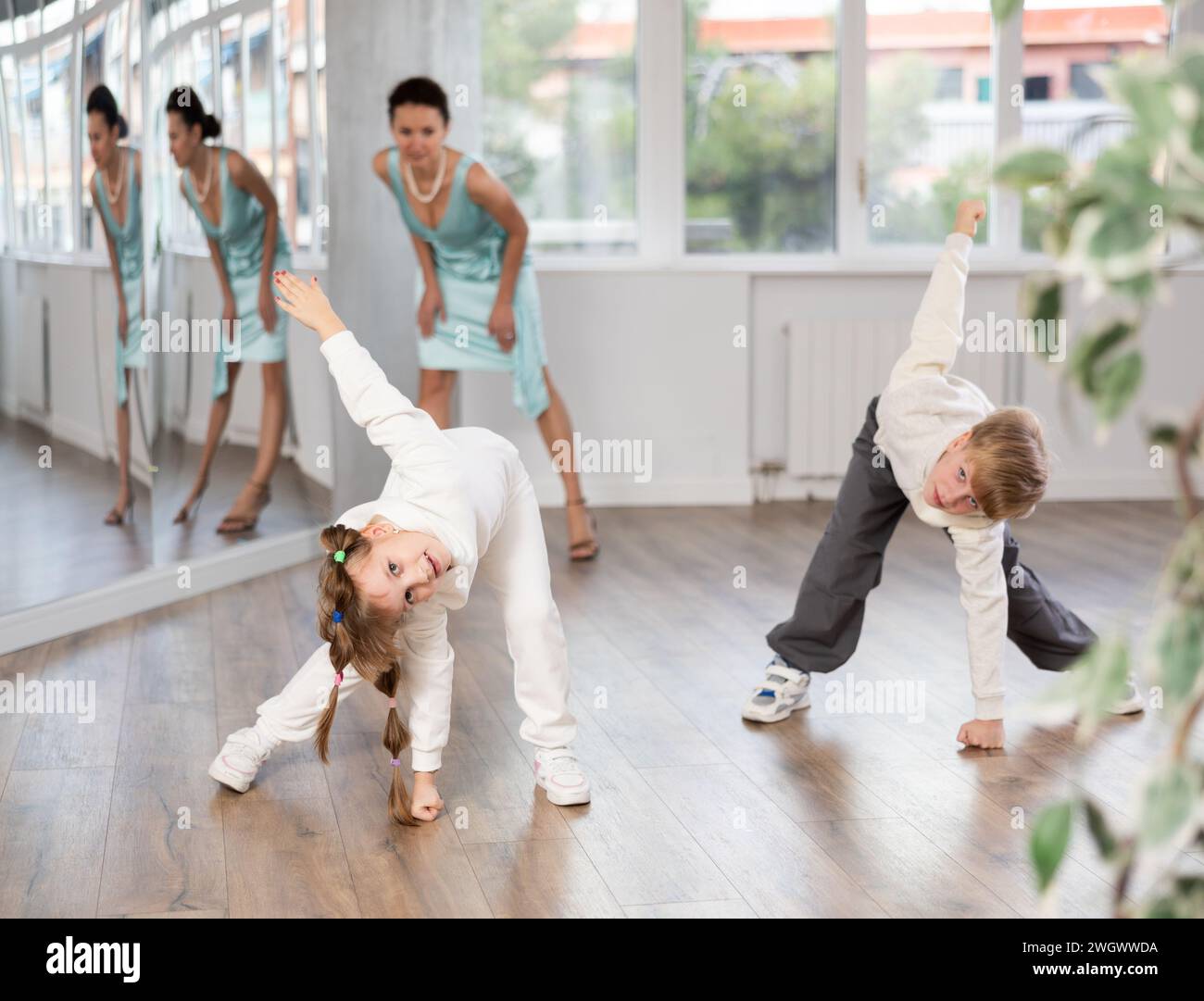 Boy and girl train to dance contemporary vigorous hip hop during ...