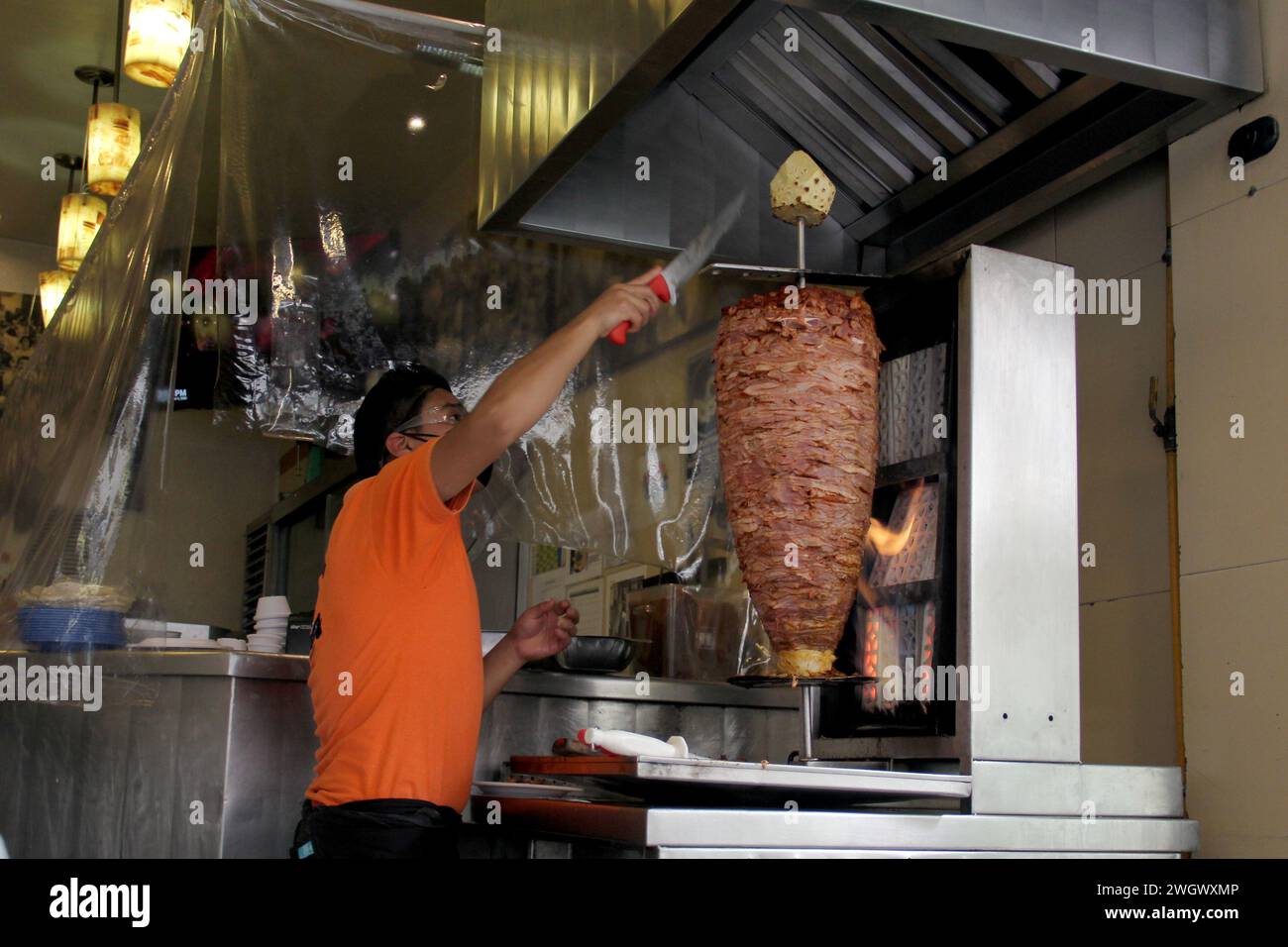 Latino taquero man working with protection mask, typical mexican food ...