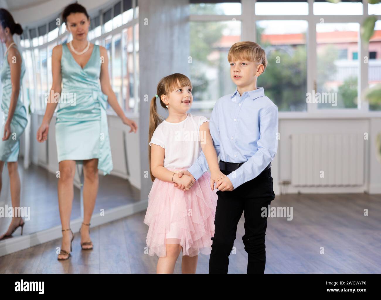 Boy and girl train to dance contemporary vigorous rumba during classes ...