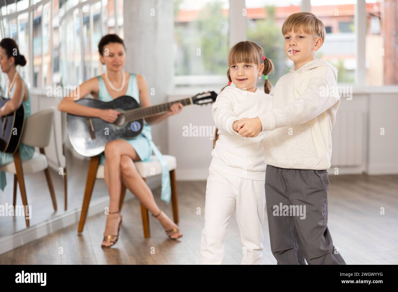 Boy and girl in pair train to dance tango during classes with ...
