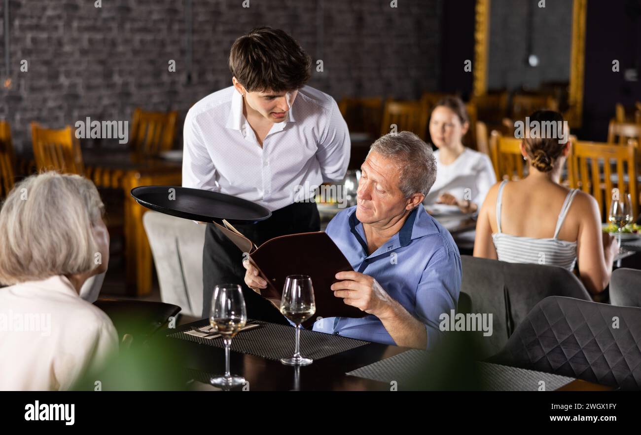 Guy looking at menu hi-res stock photography and images - Alamy