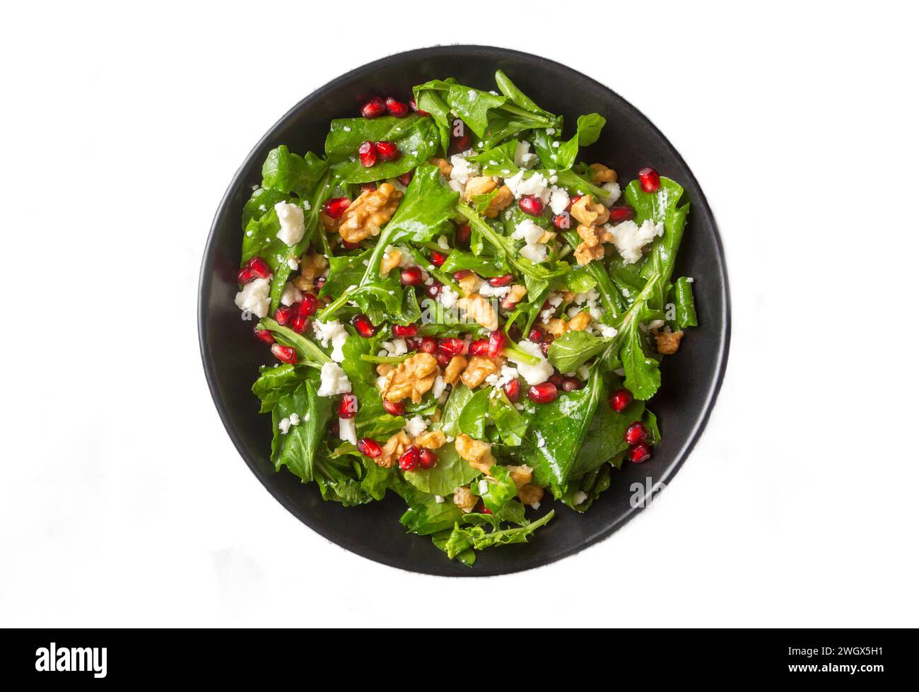 Arugula salad with cheese served with walnuts and pomegranate. Turkish ...