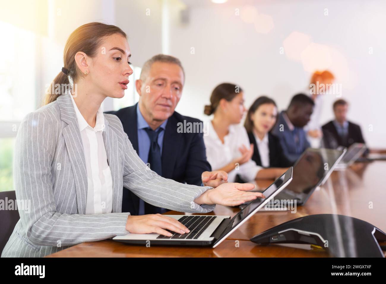 Young woman assistant talking with her boss during meeting Stock Photo ...