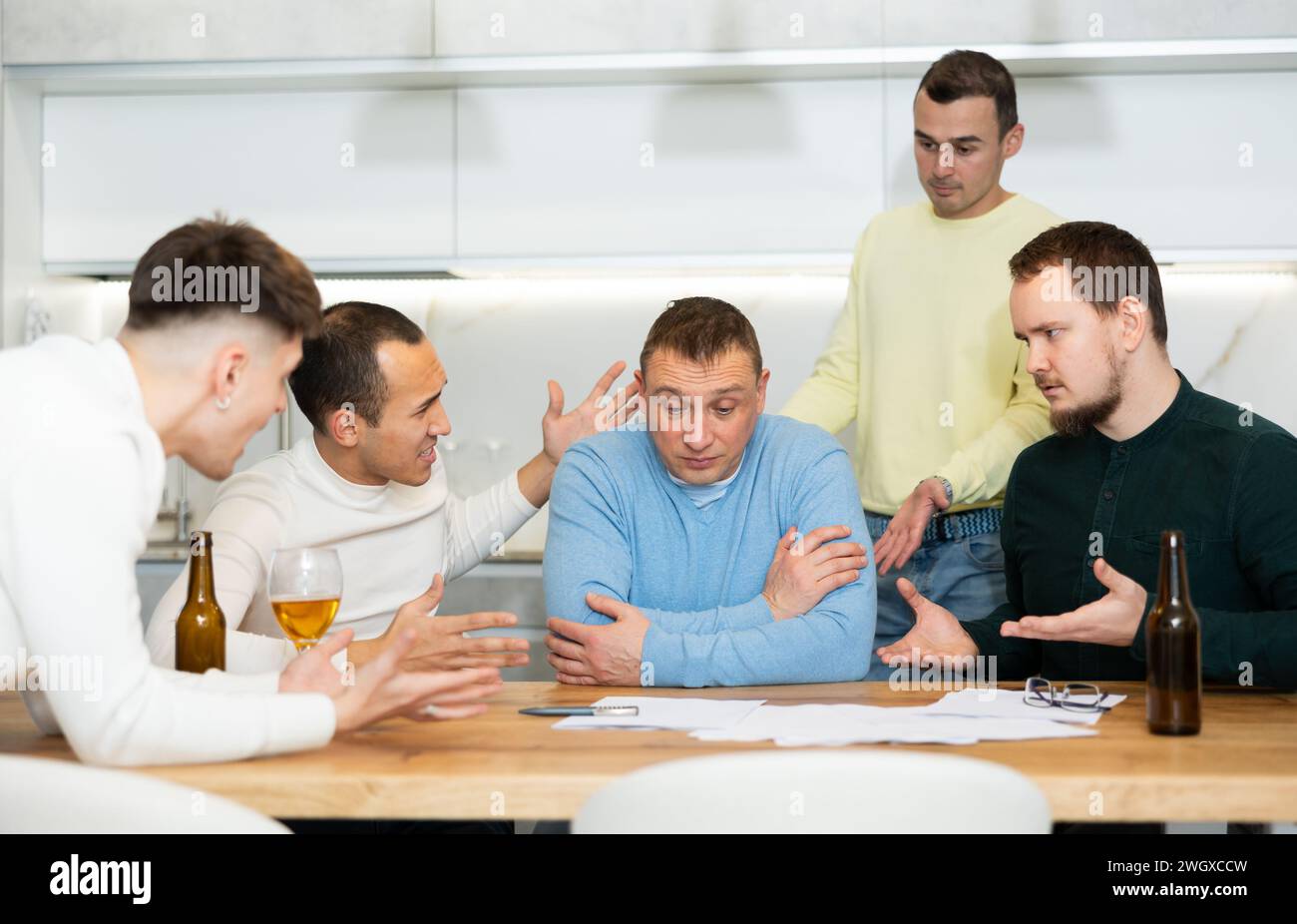 Group of men supporting troubled friend reading legal notice Stock ...