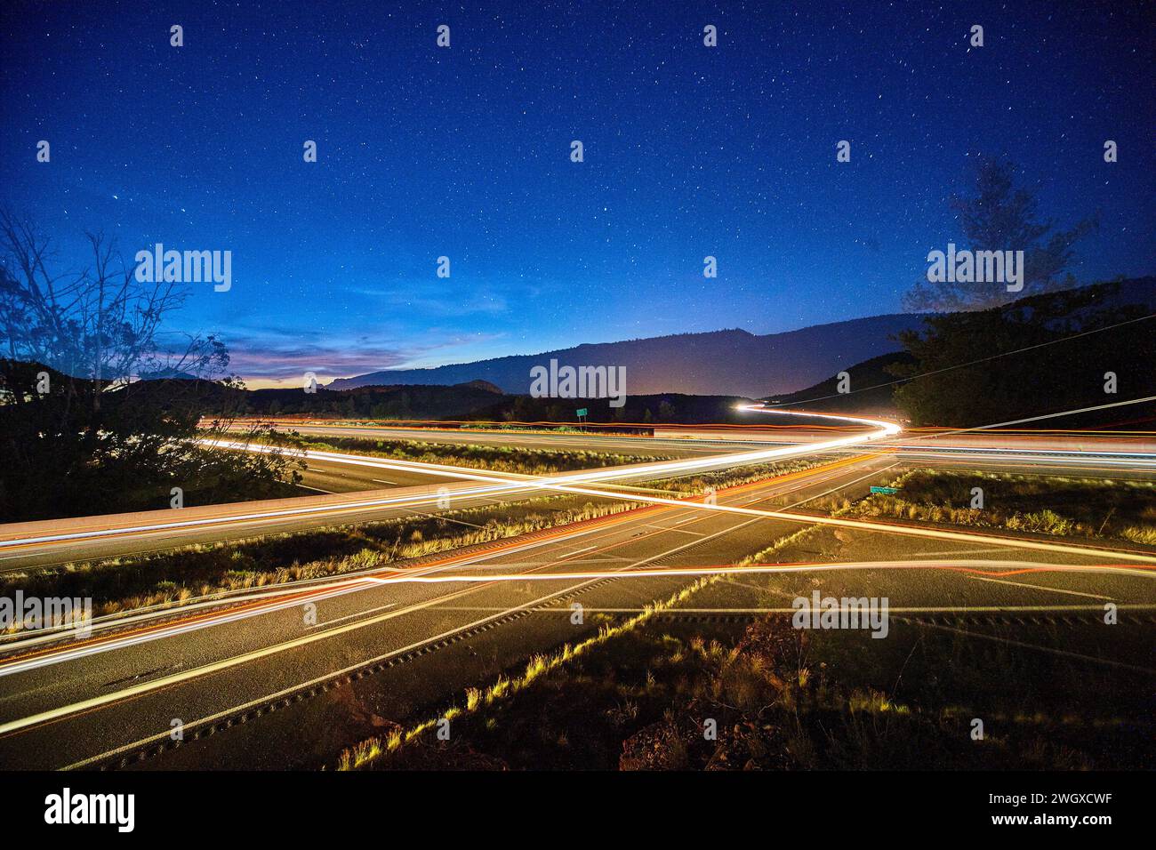 Light trails on curved road at night hi-res stock photography and ...