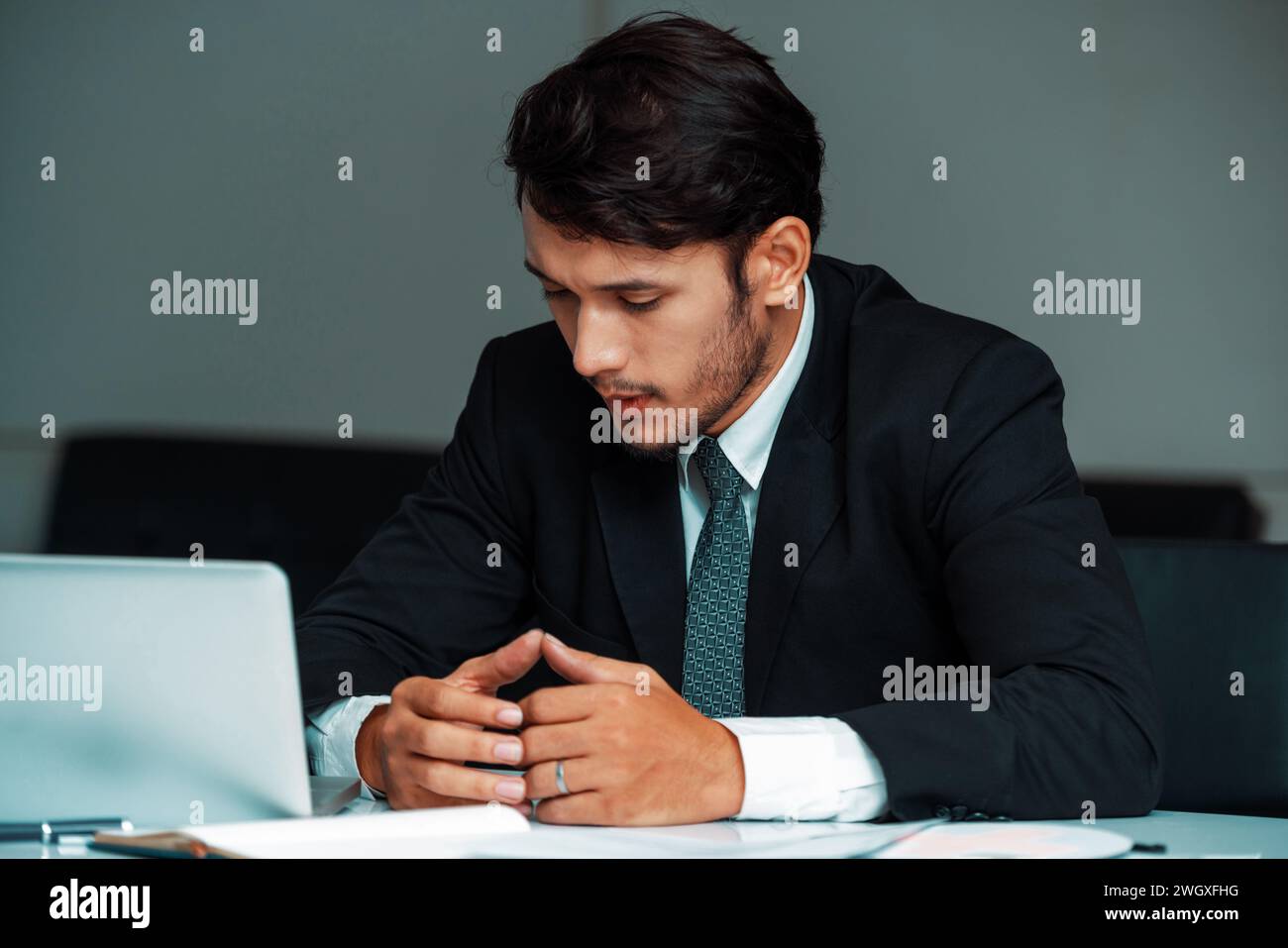 Unhappy young man, businessman feels stress at the office because of ...