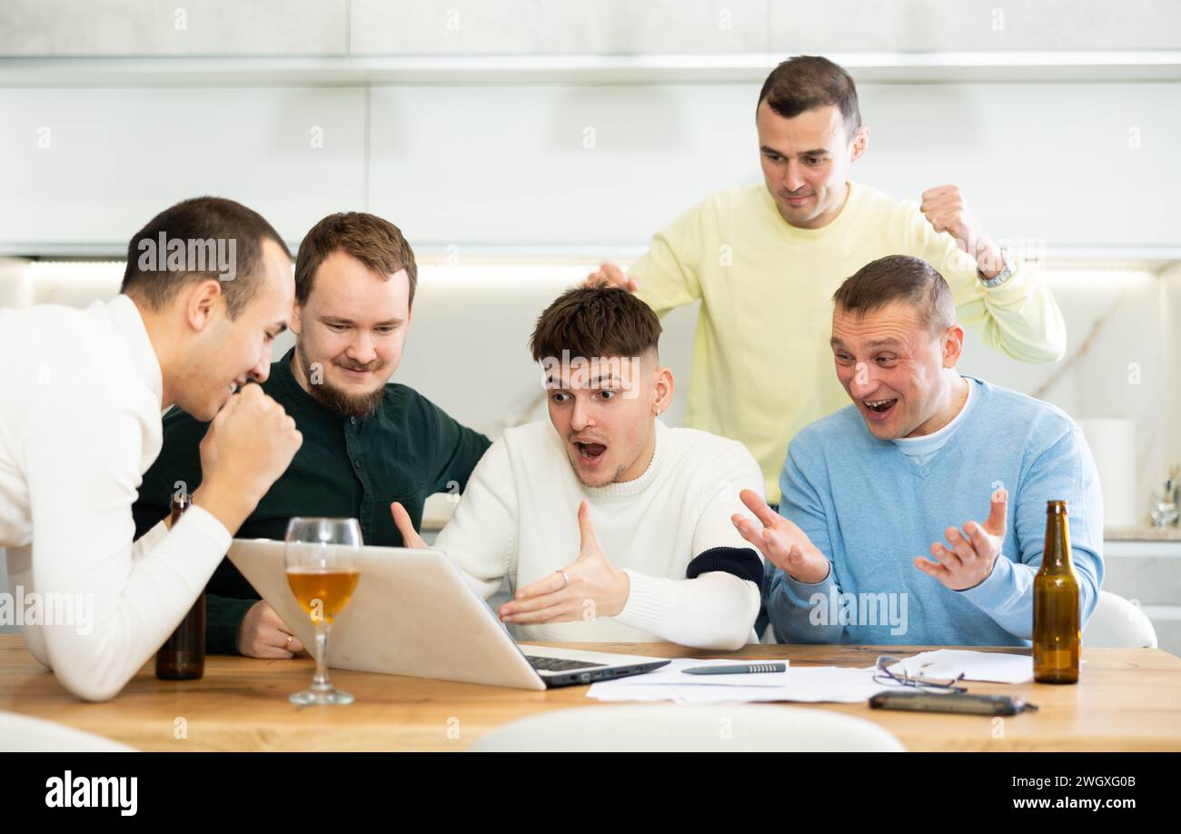 Excited friends cheering winning score in online game Stock Photo - Alamy