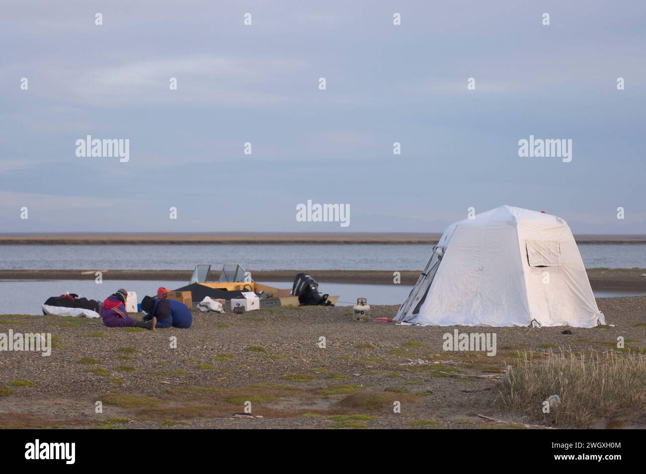 Eskimo Inupiat people kids playing at camp on a sandspit along ...