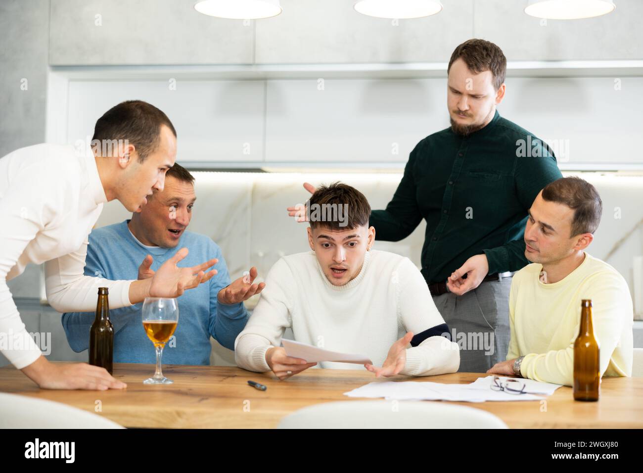 Group of men supporting troubled friend reading legal notice Stock ...