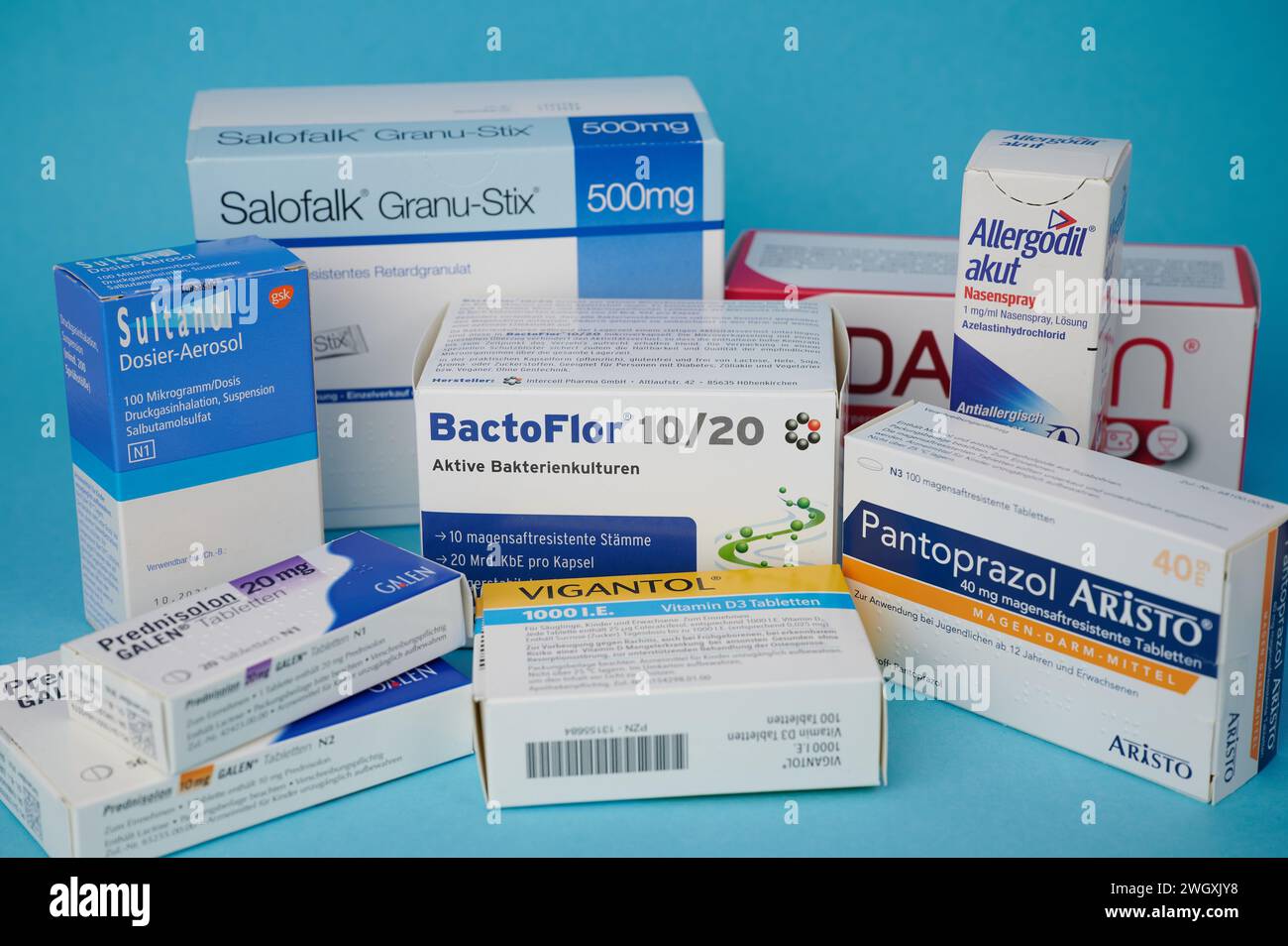many different medication packs on a blue background, including ...