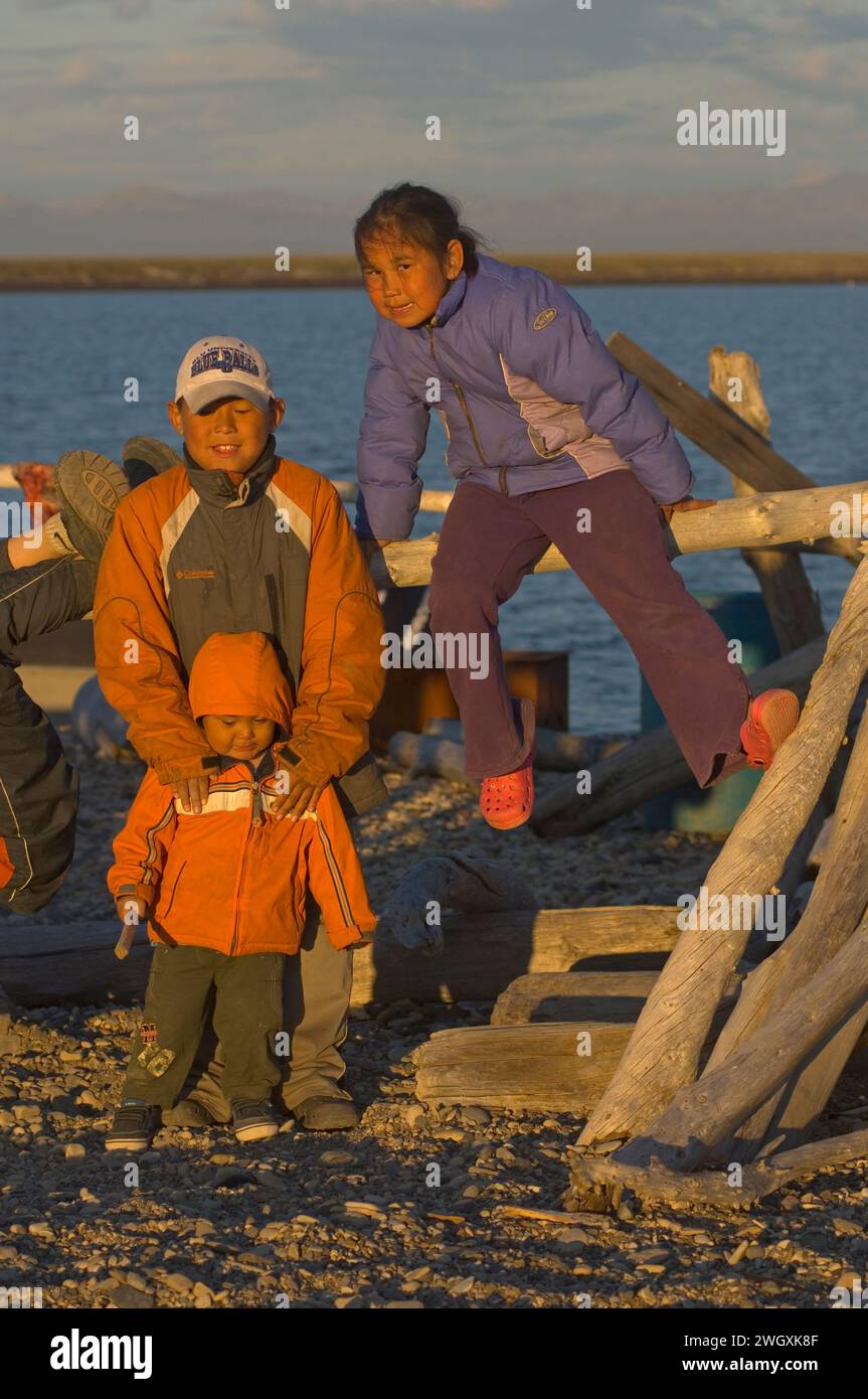 Eskimo Inupiat kids playing at camp on a sandspit along Demarcation bay ...