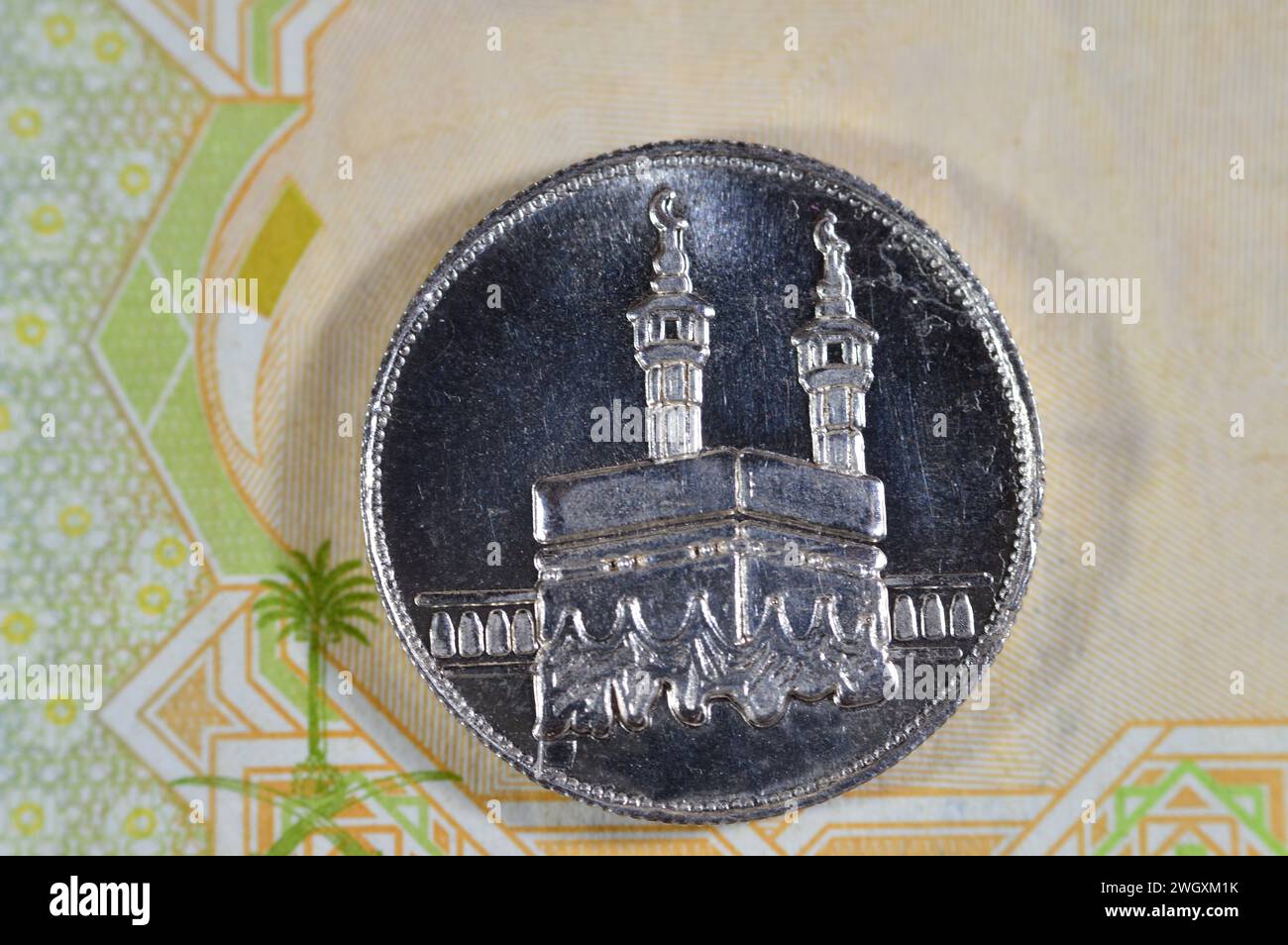 An Islamic pound coin of pure precious silver metal features Kaaba and ...