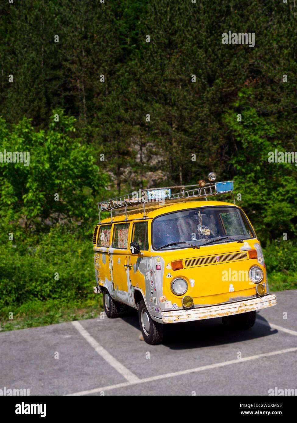 Yellow camper van in the woods. High quality photo Stock Photo - Alamy