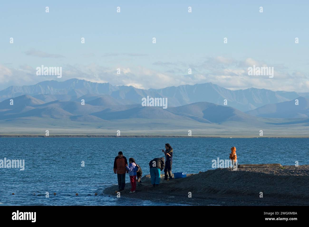 Eskimo Inupiat people kids playing at camp on a sandspit along ...